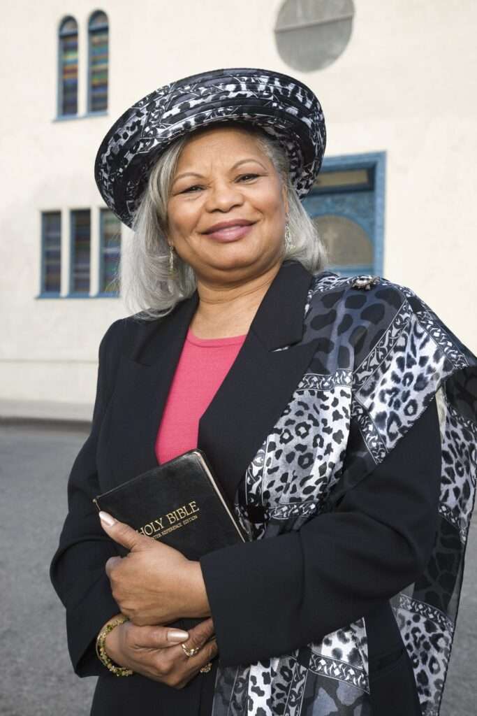 Senior African American woman in front of church - Jay Harold